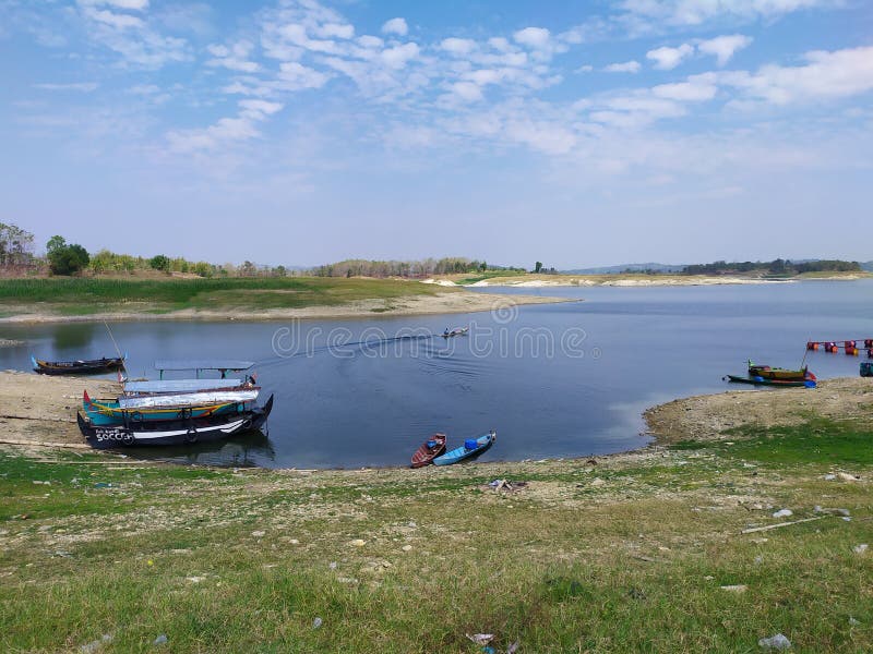 Fishing Boat on the Edge of the Lake with Blue Sky Stock Image - Image ...