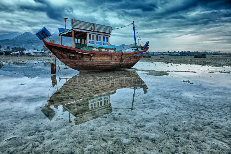 Fishing Boat during Low Tide Stock Photo - Image of stuck, seashore ...