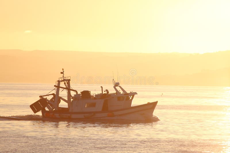 Fishing boat at sunset stock image. Image of fishery - 28487129