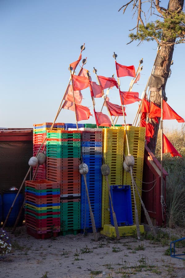Fishing Crates and Red Flags. Stock Image - Image of boxes, blue: 127832355