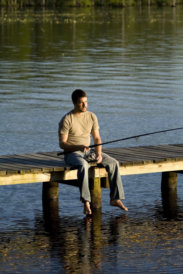 Man fishing off a dock stock image. Image of lake, male - 5358167