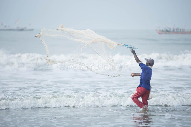 A Fisherman Casting His Net From The Beach Editorial Stock Image ...