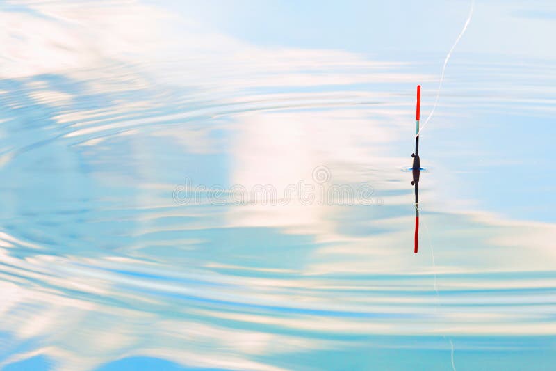 A Fishing Float Floats on the Water of the Lake Making Circles in the ...