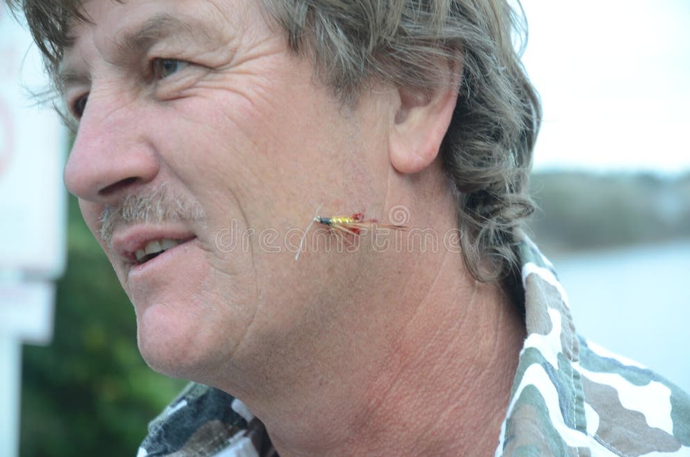 Fishing Fly in Face stock photo. Image of eyes, yellow - 95121352
