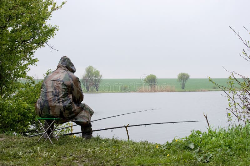 Fishing on a Lake in Bad Weather Stock Photo - Image of rain, plant ...