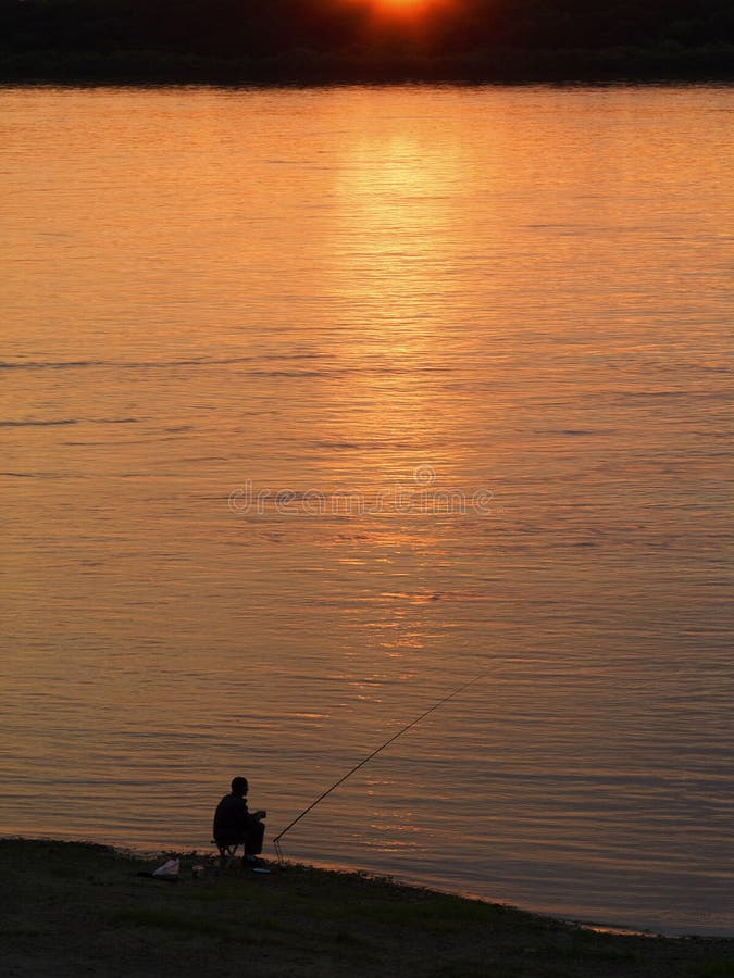 Alone Man is Standing on the Dock Pier and Watching Sunrise Sunset with ...
