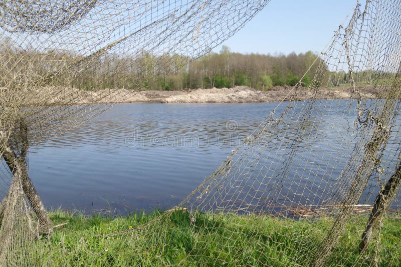 Fishing net on lake shore stock image. Image of tourism - 365089425