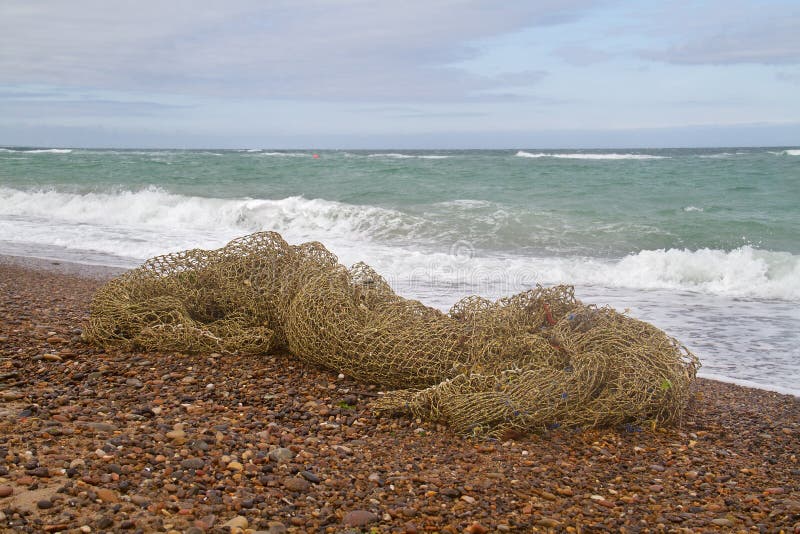 Fishing Net on Pebble Beach Stock Image - Image of neglect, equipment ...