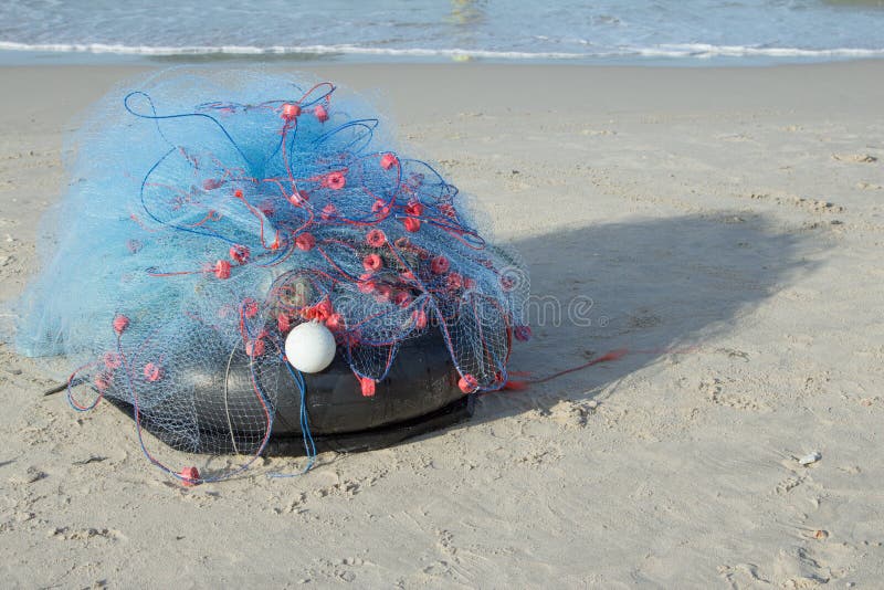 The Fishing Net is on the Rubber Wheel and on the Beach. Stock Photo ...