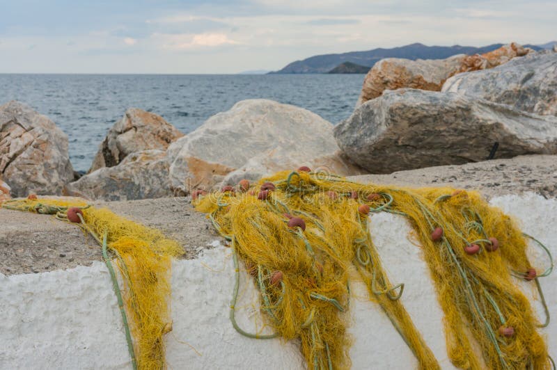 Fishing Nets on a Concrete Pier by the Sea Stock Photo - Image of ...