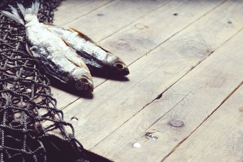 Fishing Nets and Dried Fish Still-life on the Wooden Background. Stock ...