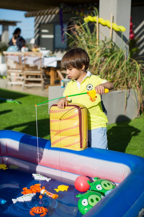Fishing in the Paddling Pool. the Children are Playing. Stock Photo ...