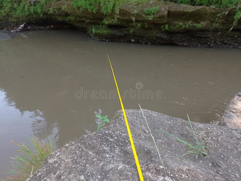 Fishing in the River with a Yellow Rod Stock Image - Image of water ...
