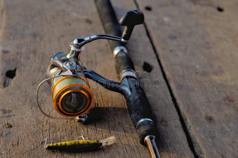 Fishing Rod and Fishing Bait on the Wooden Table. Stock Image - Image ...