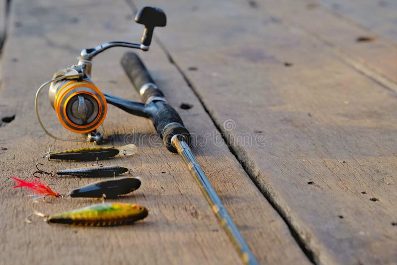 Fishing Rod and Fishing Bait on the Wooden Table. Stock Photo - Image ...