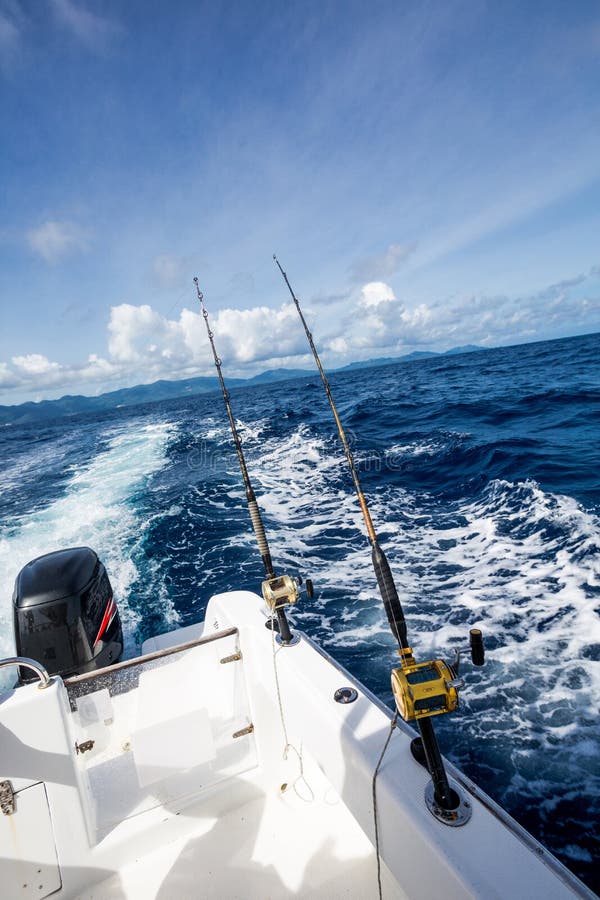Fishing rod on boat at sea stock photo. Image of clouds - 36017862