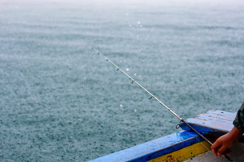 Fishing Rod in the Boat Under the Rain. Fishing Rod, Sea, Boat and Rain ...