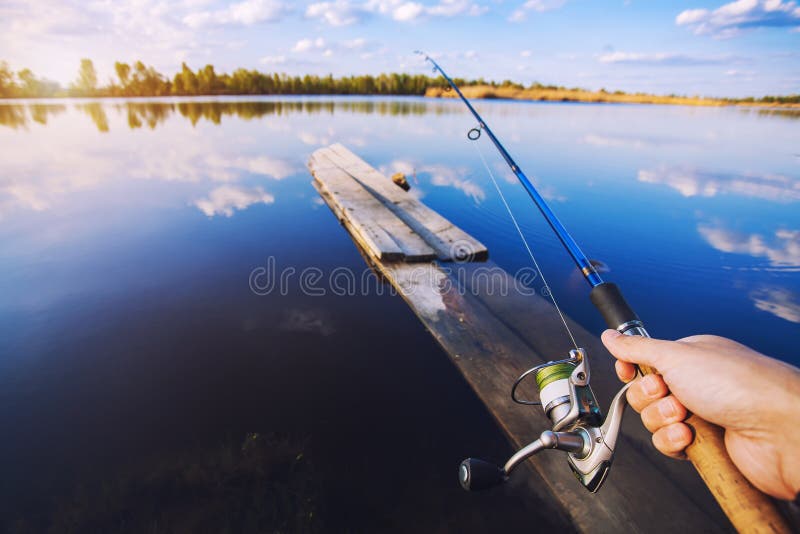 Fishing with rod on lake stock image. Image of spinning - 116868709