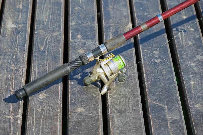 Fishing rod on the pier stock image. Image of tackle - 216350165