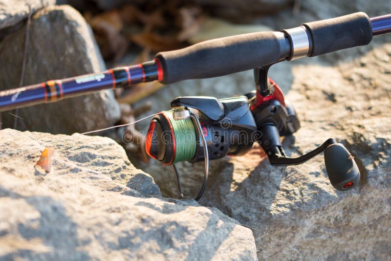 Fishing Rod and Reel on the River Rocks Stock Image - Image of closeup ...
