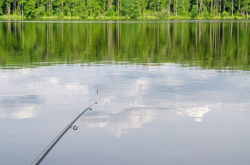 Fishing Rod, Water Surface, Float, Day, Reflection of Clouds. Stock ...