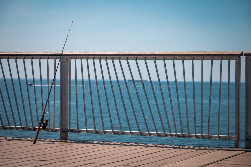 Fishing Rod on a Wooden Dock by the Sea Stock Image - Image of hobby ...