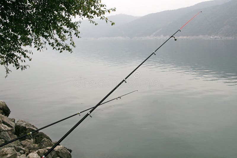 Fishing Rods Over the Water Stock Photo - Image of mountain, water ...