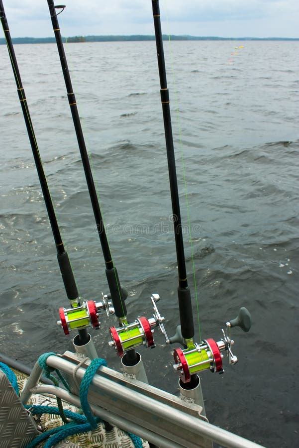 Fishing Rod Spinning with the Line Close-up. Fishing Rod in Rod Holder ...