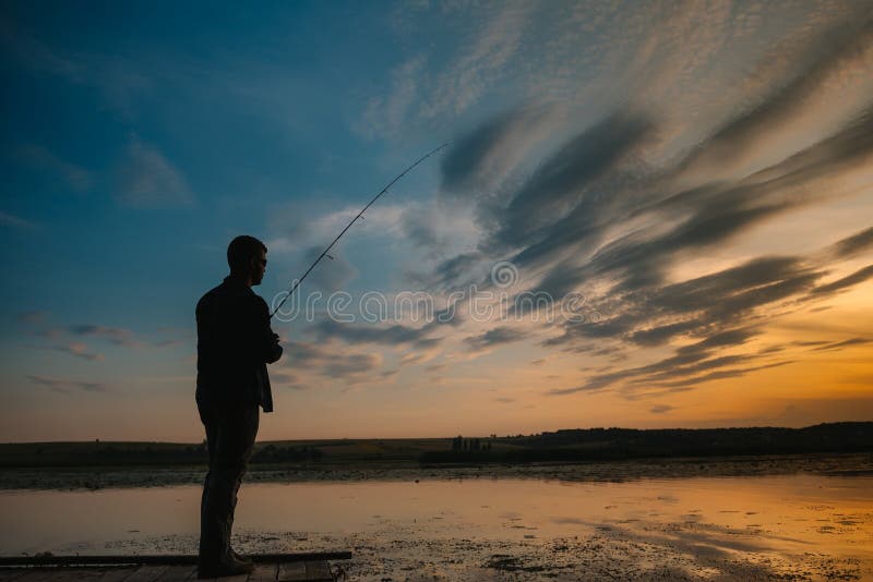 Fishing. Spinning at Sunset. Silhouette of a Fisherman. Stock Image ...