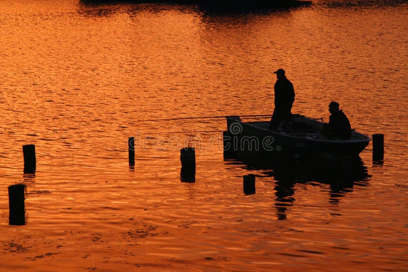 Fishing at sunset stock photo. Image of lake, evening - 1004064
