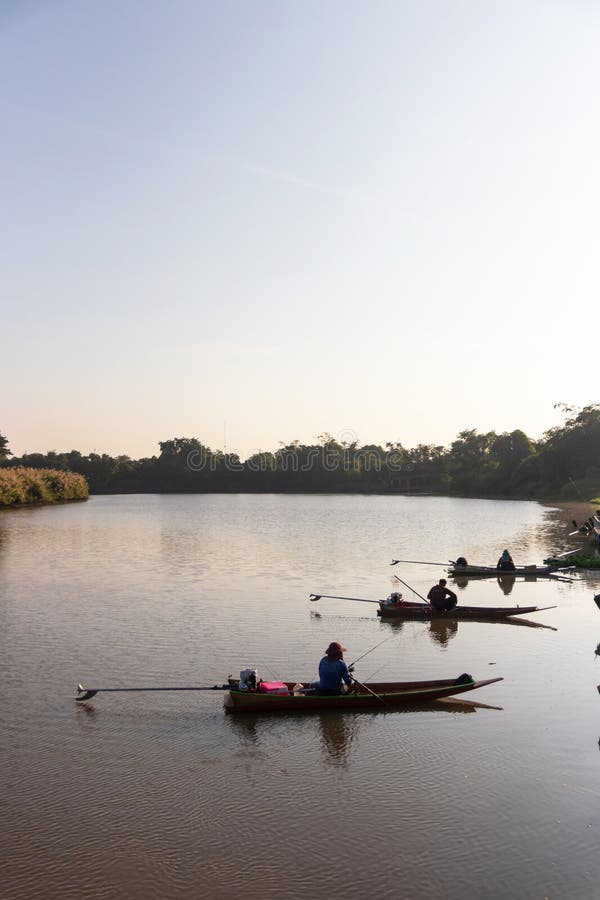 Fishing at Sunset on Calm Waters with Boats Stock Image - Image of ...