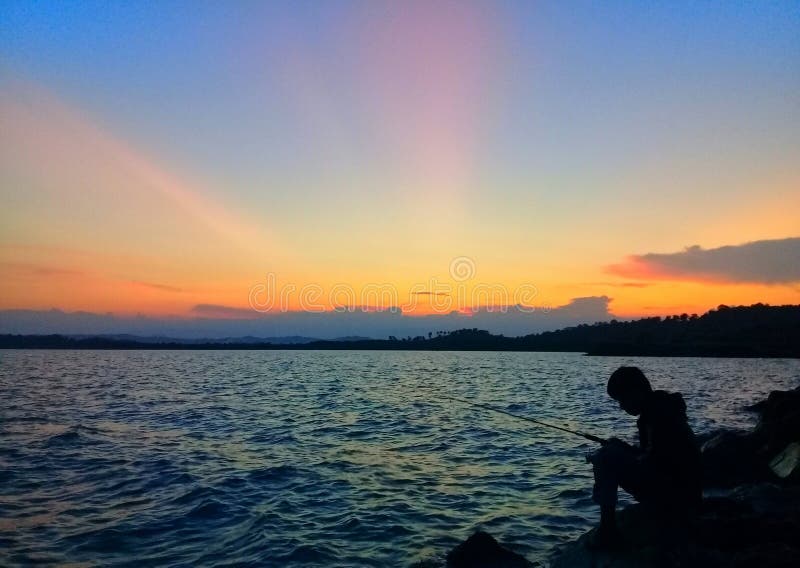 Fishing at sunset stock image. Image of caught, lure - 263109507