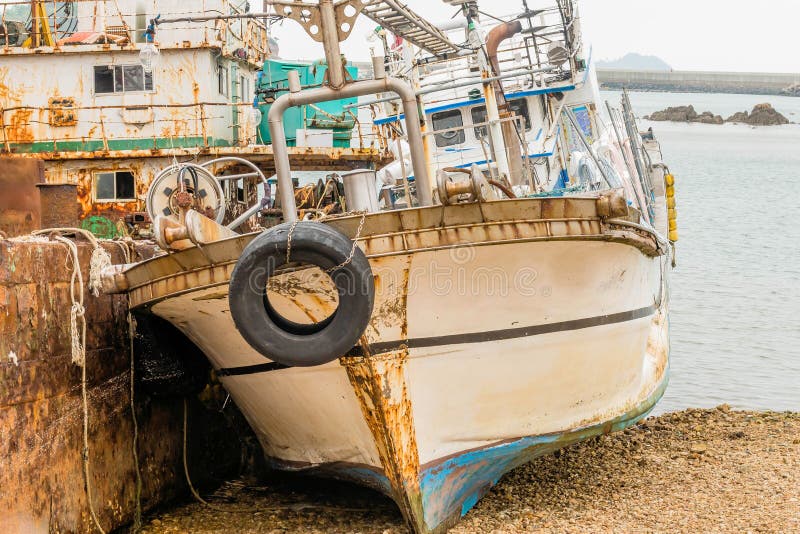 Fishing Trawler Beached beside Barge Stock Photo - Image of coastline ...