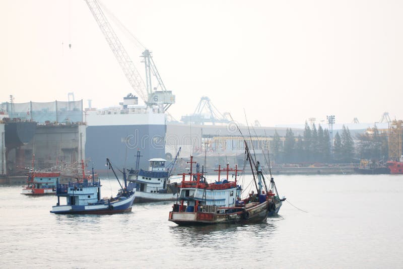 Fishing Vessel and Cargo Ship in Port. Stock Photo - Image of repair ...