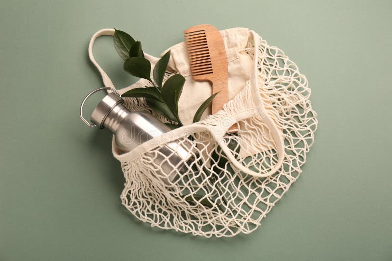 Fishnet Bag with Different Items on Pale Green Background, Top View ...