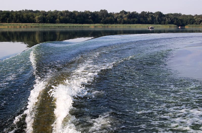 Fishtail Wave and Bank of River Behind Inflatable Engine Boat Stock ...