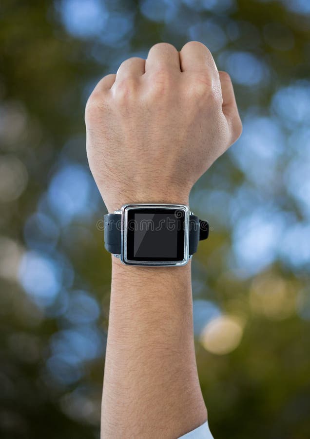 Fist in Air with Watch Against Blurry Leaves Stock Image - Image of ...