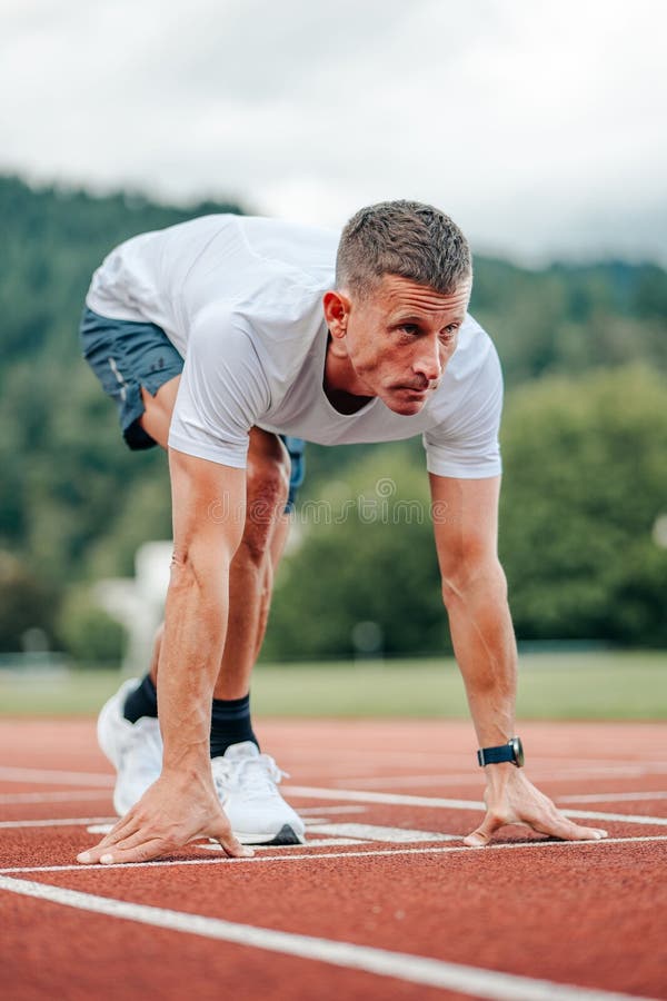 Fit, Active Man Stands on a Marked Start Line, Ready To Begin a Workout ...
