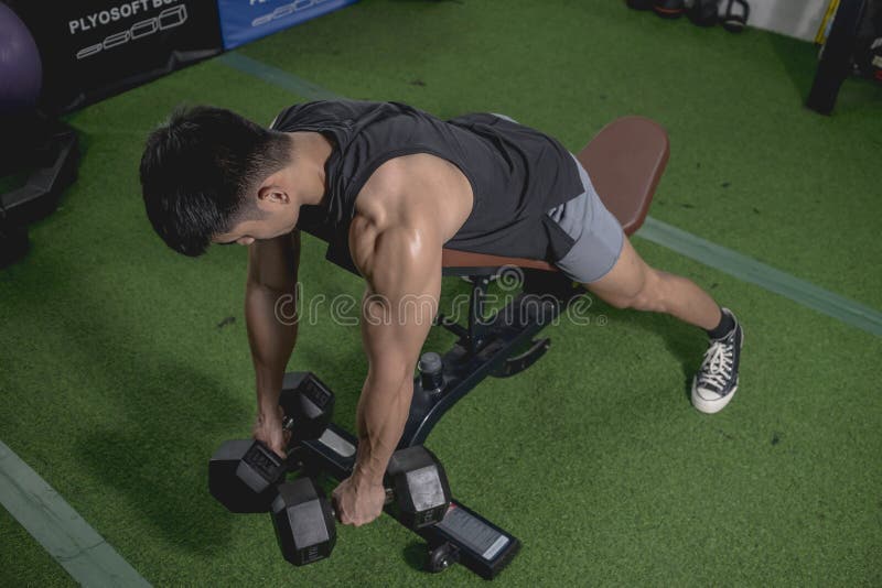 A Fit Asian Guy Does Chest Supported Dumbbell Row on an Incline Bench ...