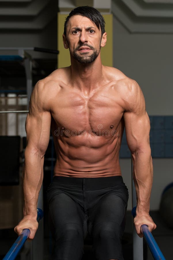 Fit Athlete Doing Exercise on Parallel Bars Stock Photo - Image of ...