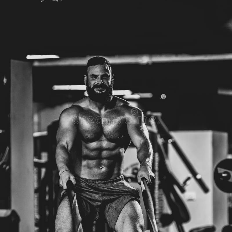 Bodybuilder pulling rope stock photo. Image of exercise - 165418200