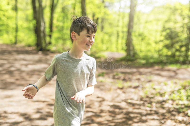 Fit Child Boy Jogging in Green Park on a Sunny Summer Evening. Stock ...