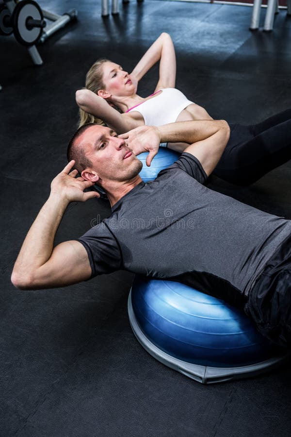 Fit Couple Doing Sit Ups on Bosu Ball Stock Image - Image of attractive ...