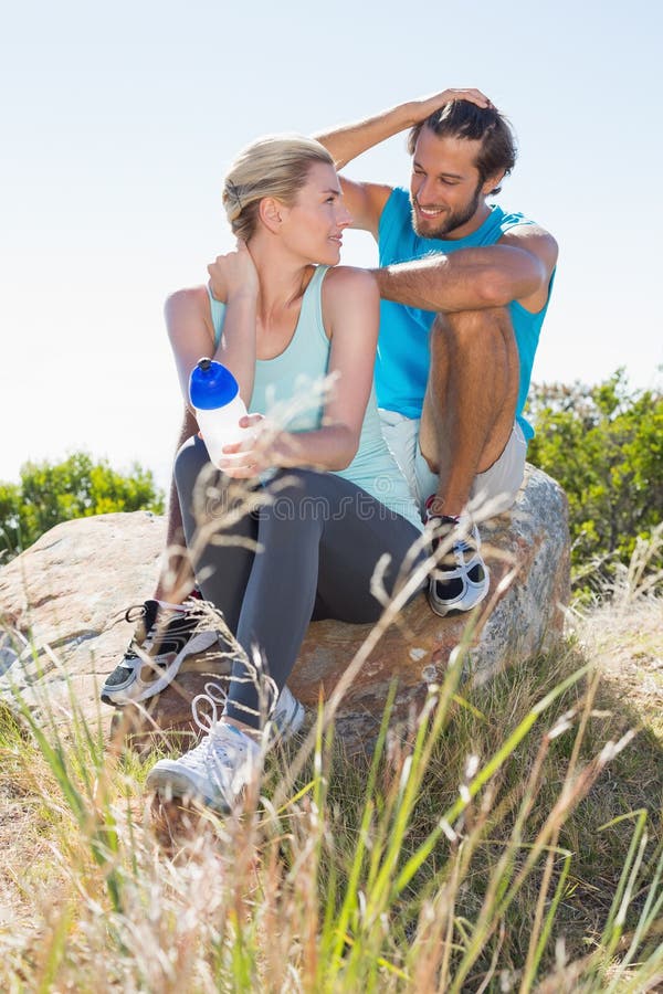 Fit Couple Taking a Break at Summit Smiling at Each Other Stock Photo ...