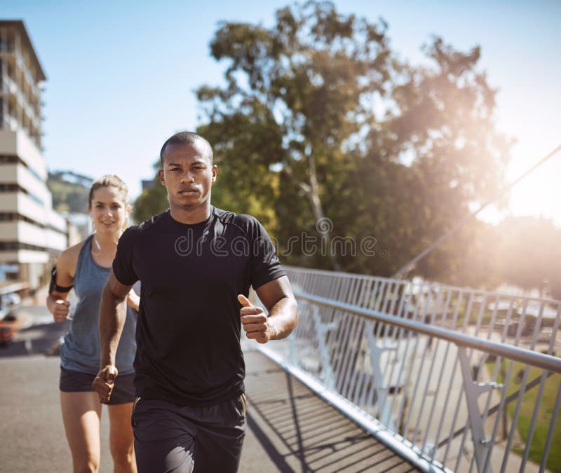 Fit and Focused. Two Young People Talking a Run in the City. Stock ...