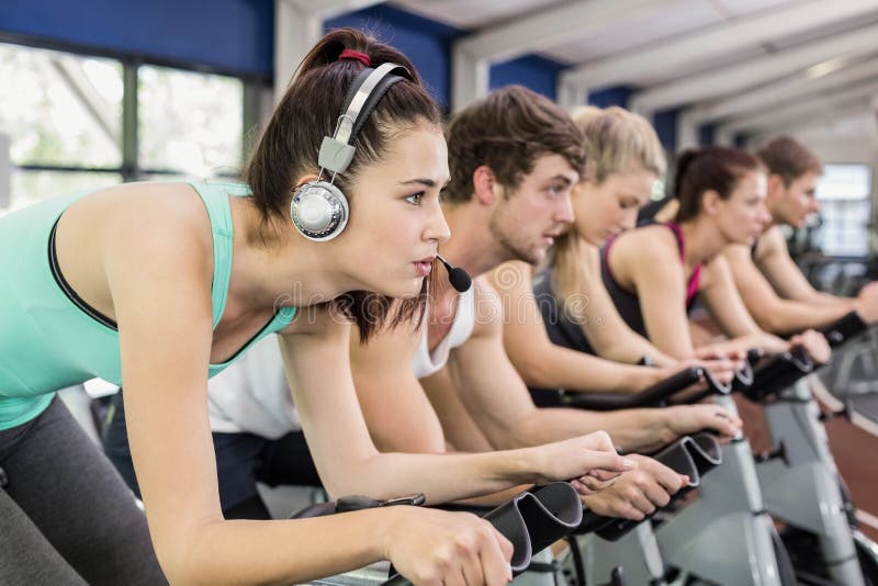 Fit Group of People Using Exercise Bike Together Stock Photo - Image of ...