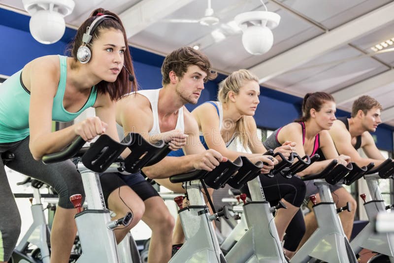 Fit Group of People Using Exercise Bike Together Stock Photo - Image of ...