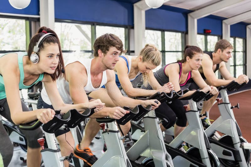 Fit Group of People Using Exercise Bike Together Stock Photo - Image of ...