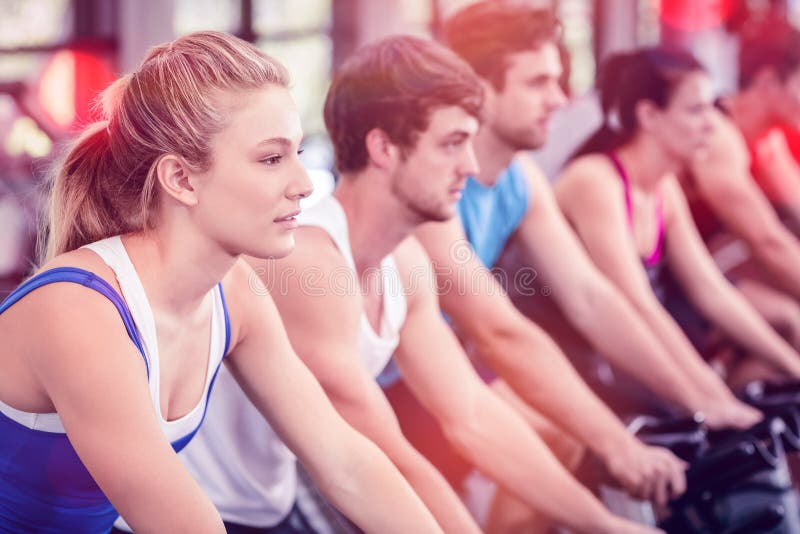 Fit Group of People Using Exercise Bike Together Stock Photo - Image of ...
