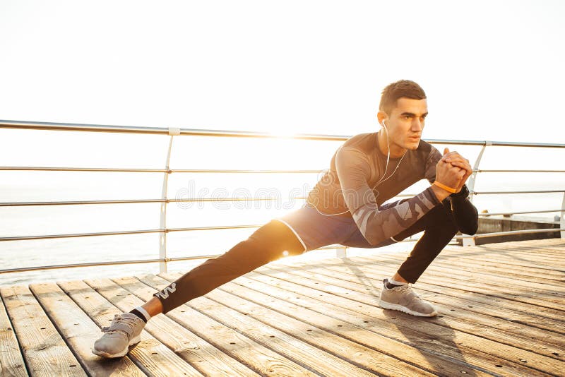 Fit Handsome Man Warming Up Stock Photo - Image of legs, muscular ...
